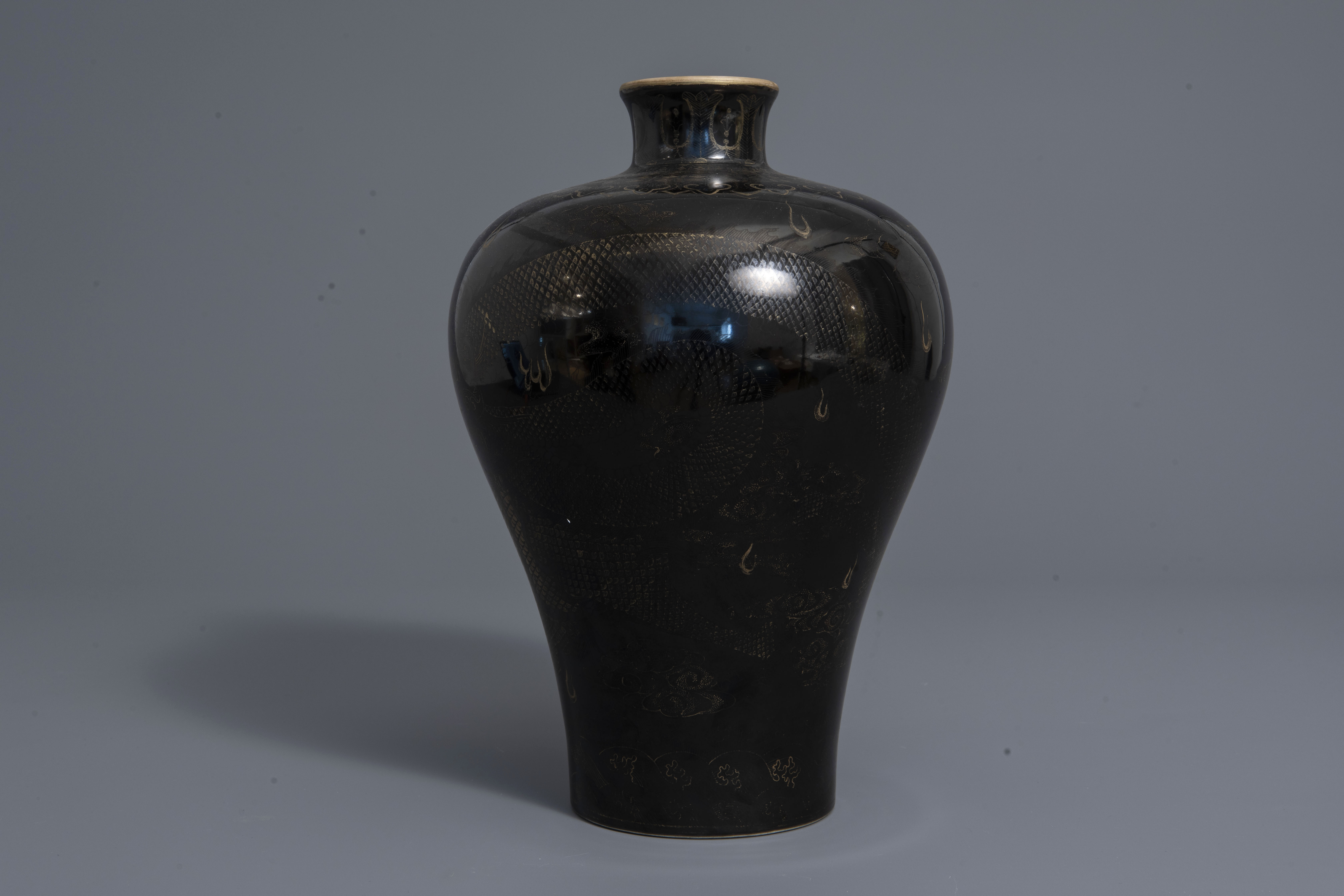 A Chinese black ground meiping vase with a gilt dragon chasing the ...