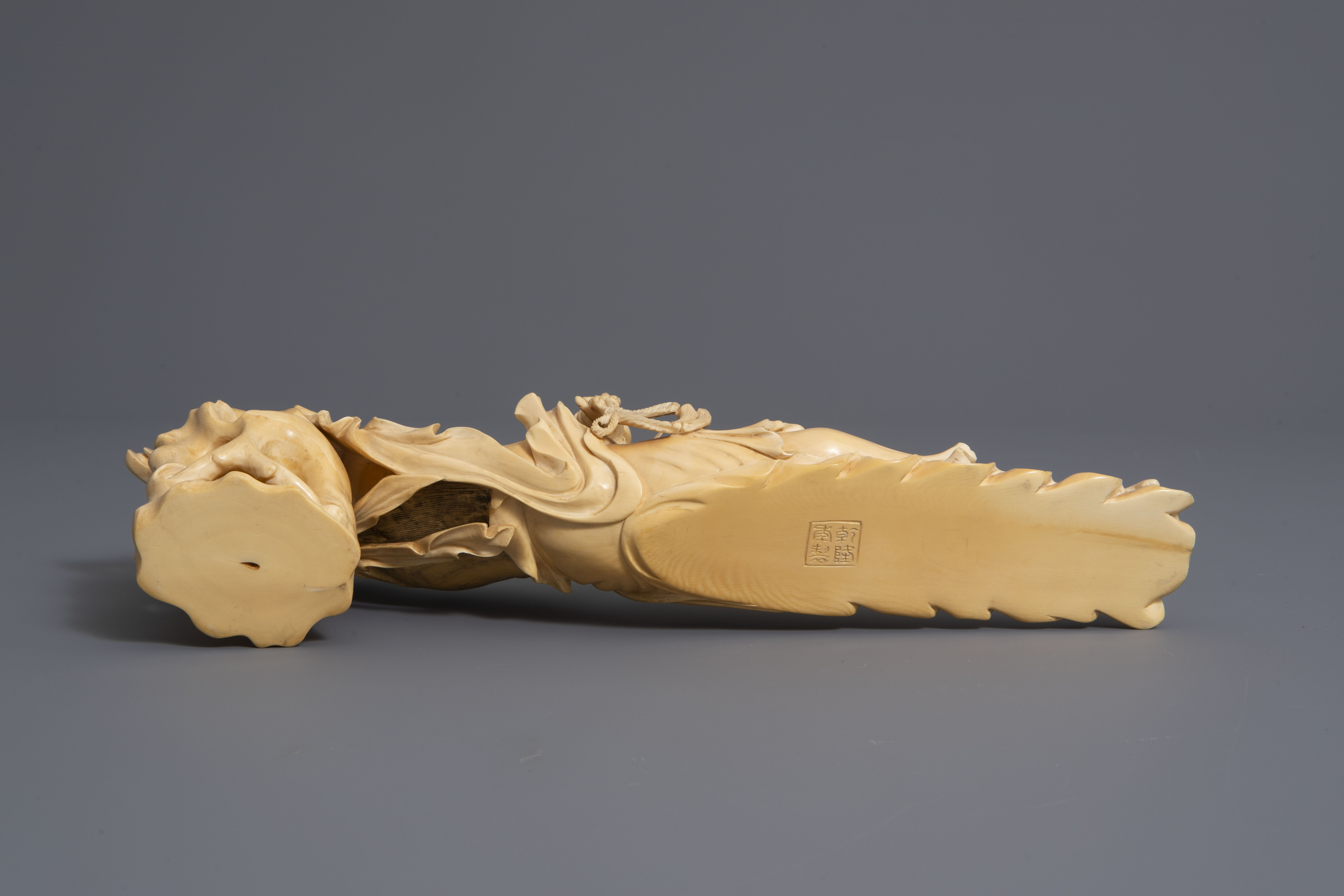 A large Chinese ivory model of a reclining lady on wooden stand, late ...