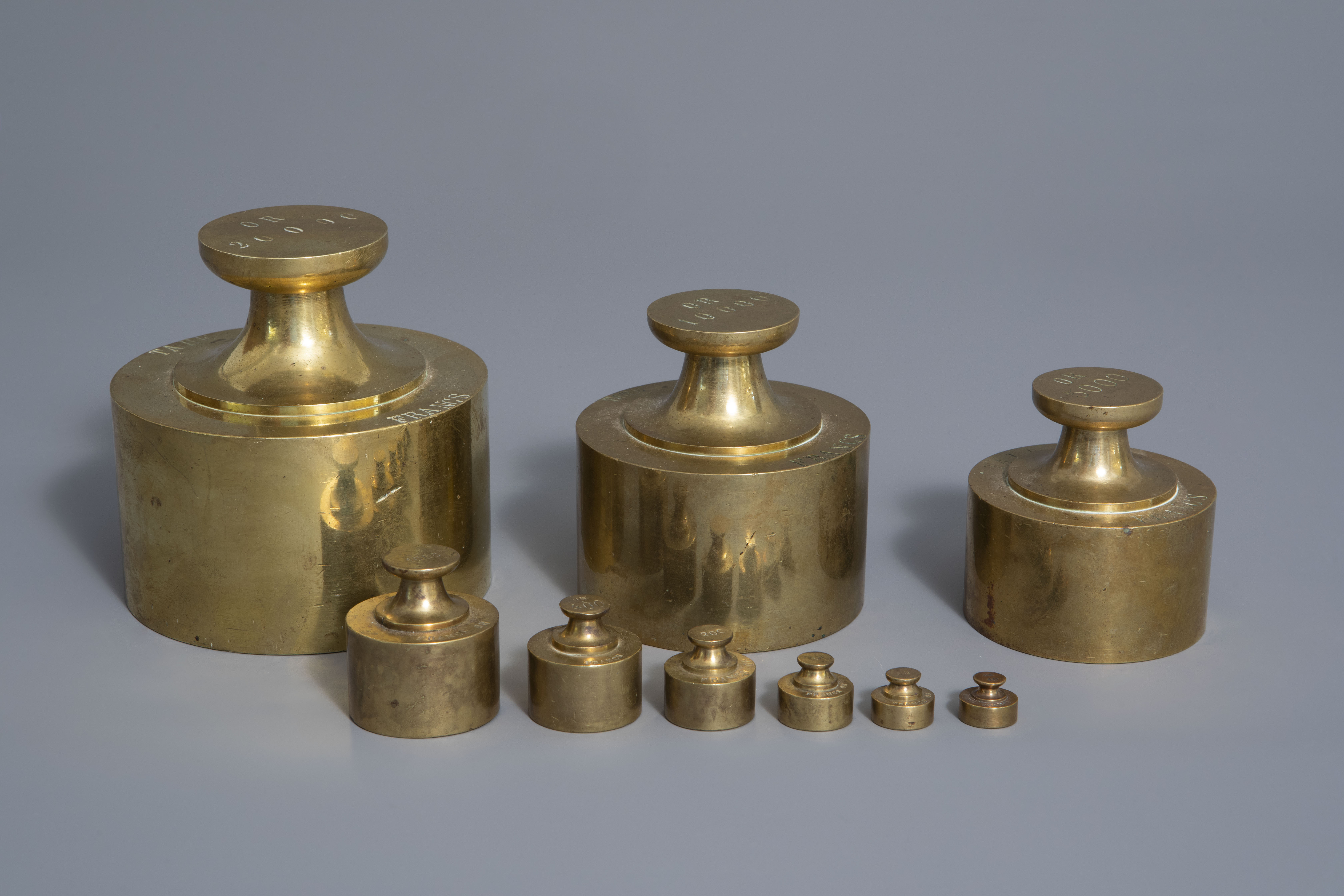 A French nine-piece set of copper bank weights for gold coins, 19th C ...