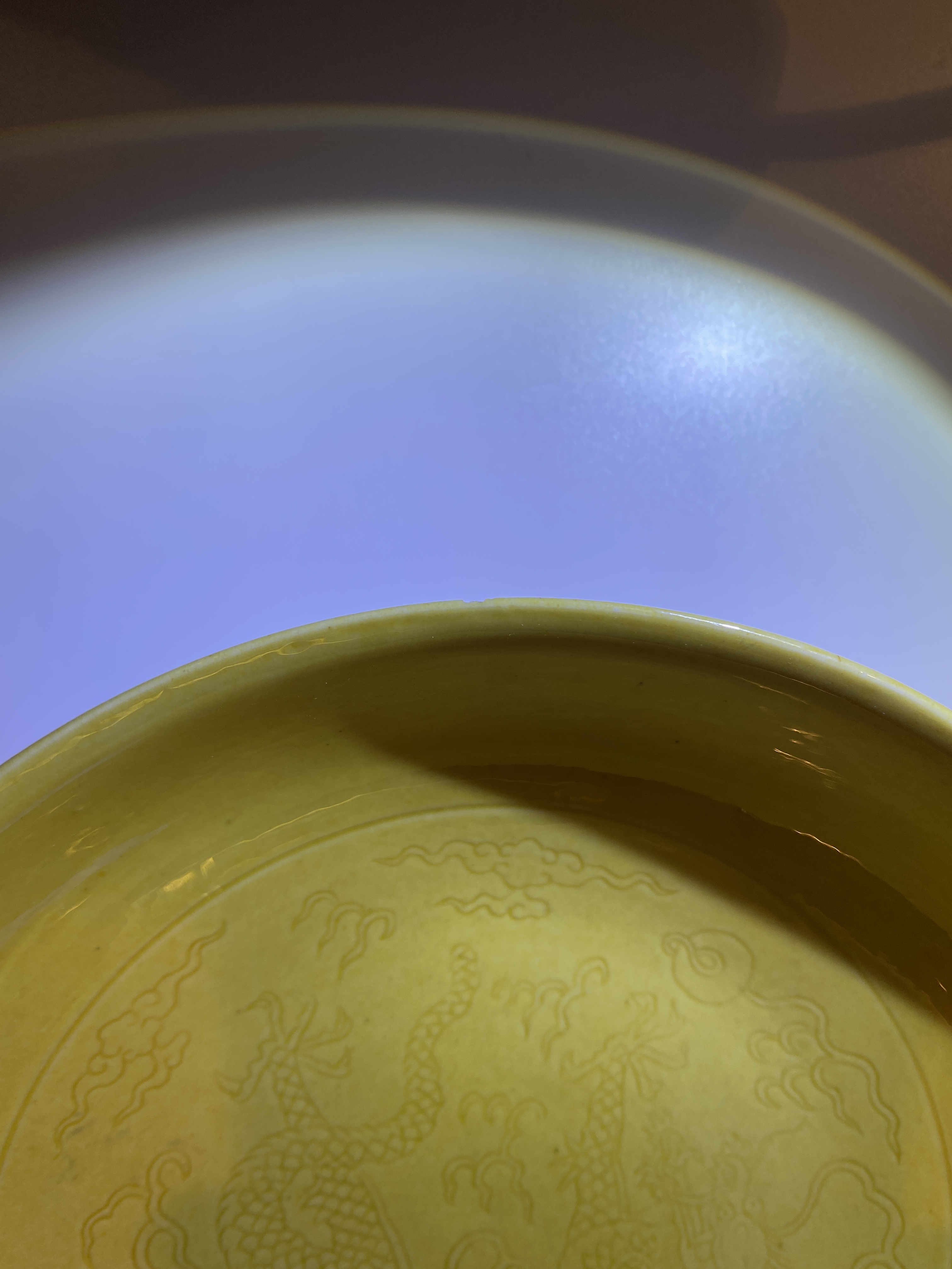 A Chinese monochrome yellow incised 'dragon' saucer dish, Daoguang mark ...