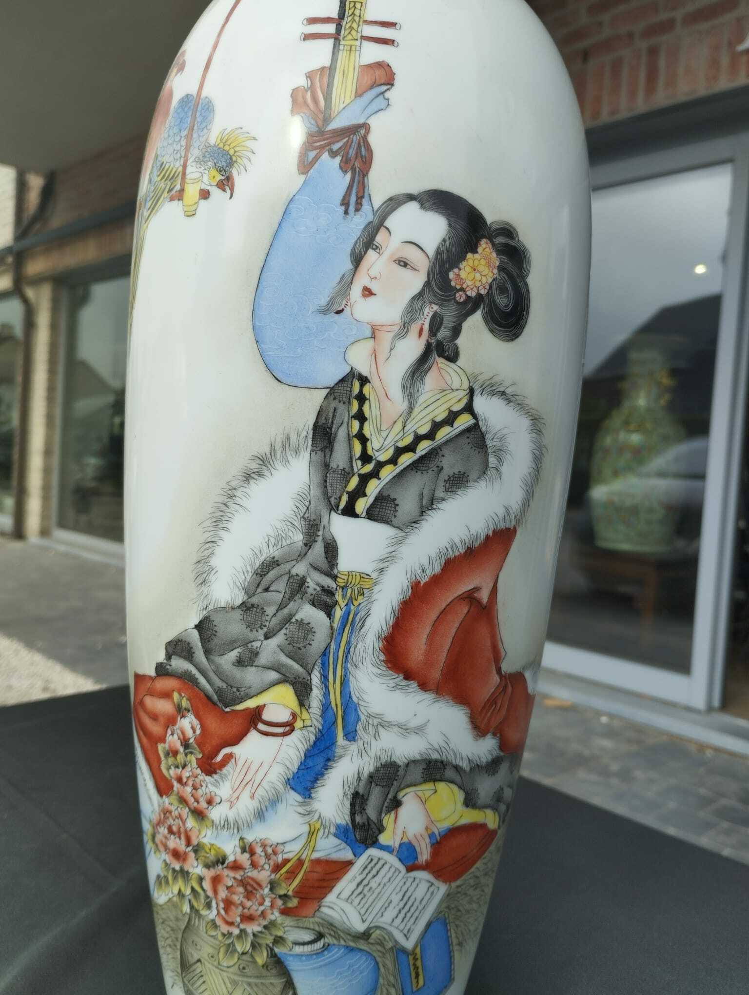 A Chinese famille rose vase with a lady and two parrots, signed Qing ...