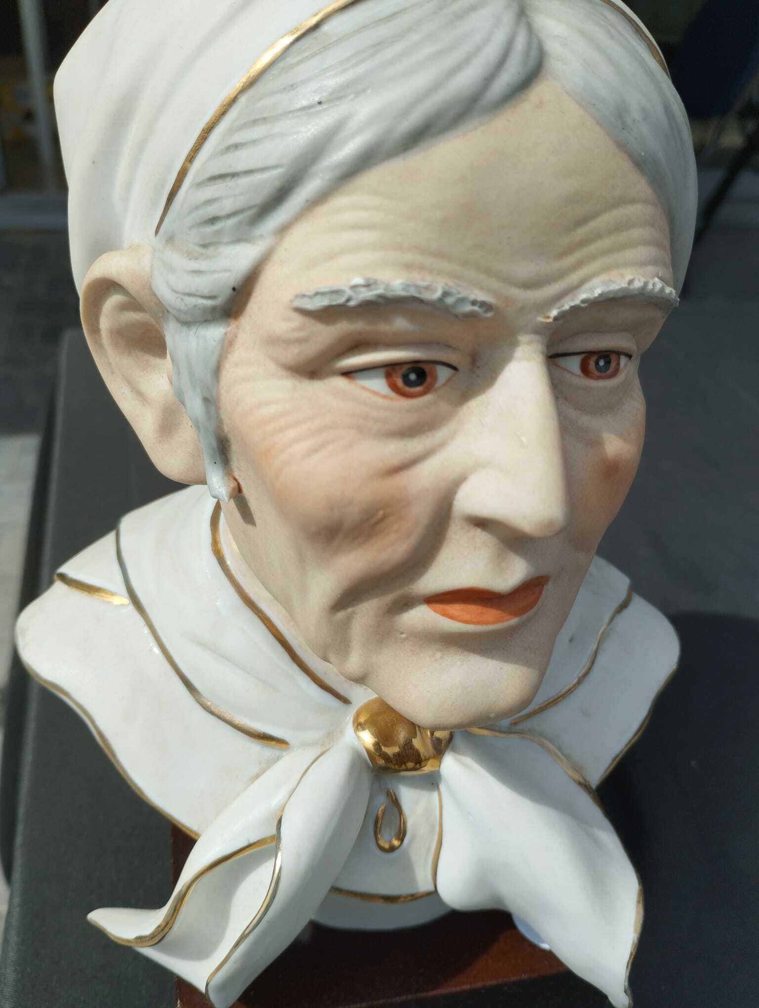 A Chinese polychrome and gilt biscuit bust of an elder in the manner of ...