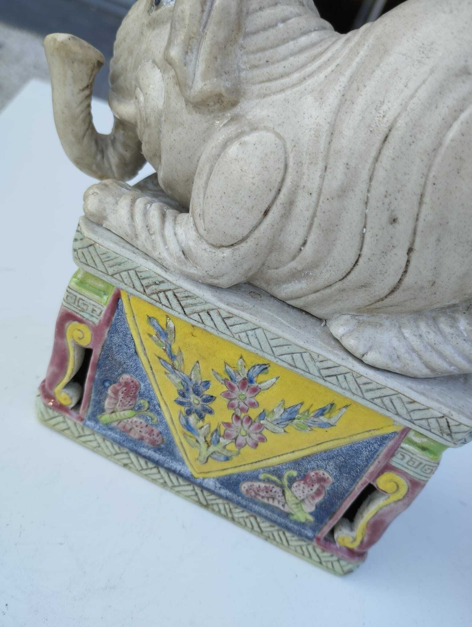 A pair of Chinese famille rose models of elephants on stands with ...