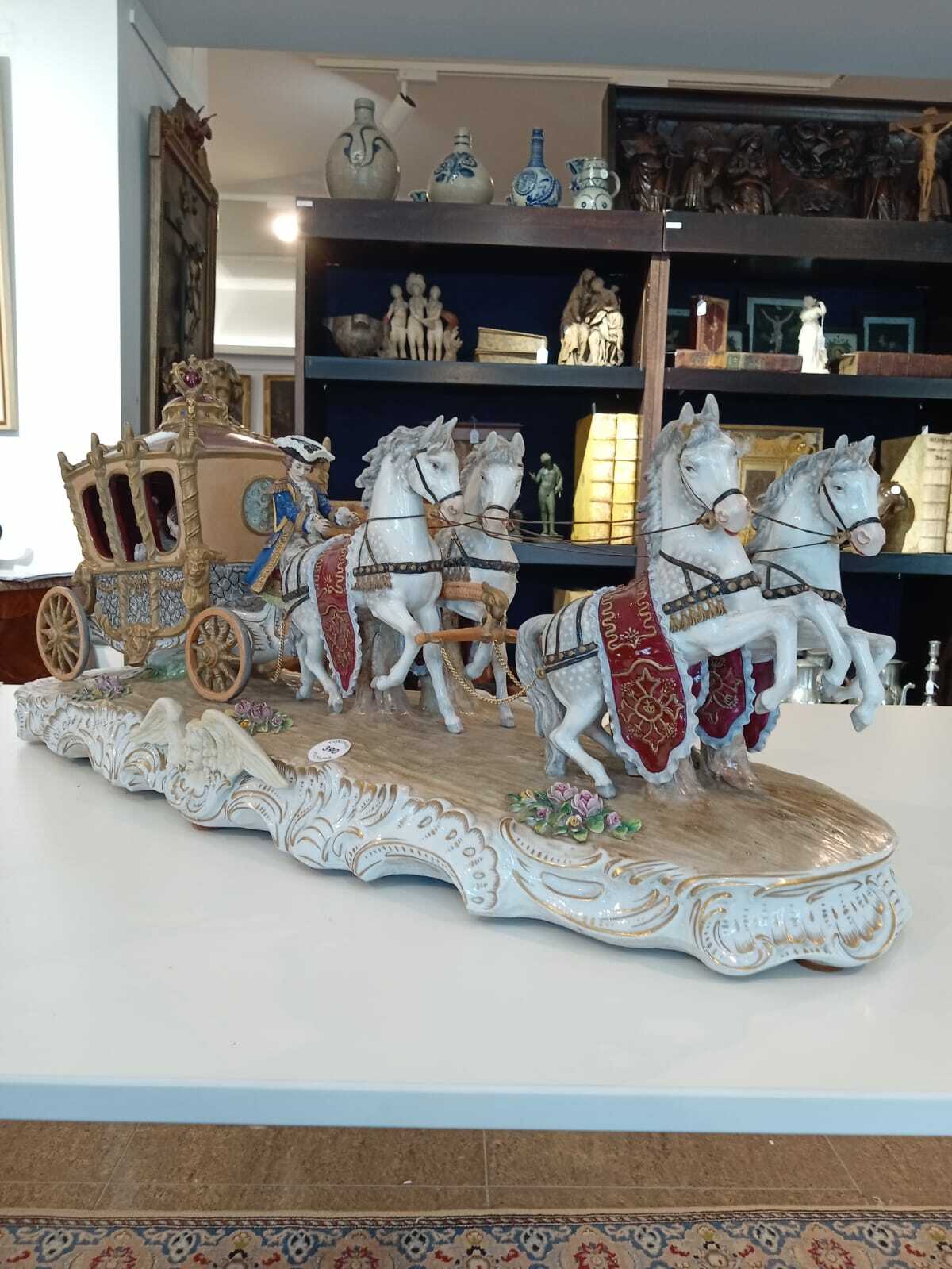 A large group with a four-in-hand carriage in polychrome decorated ...