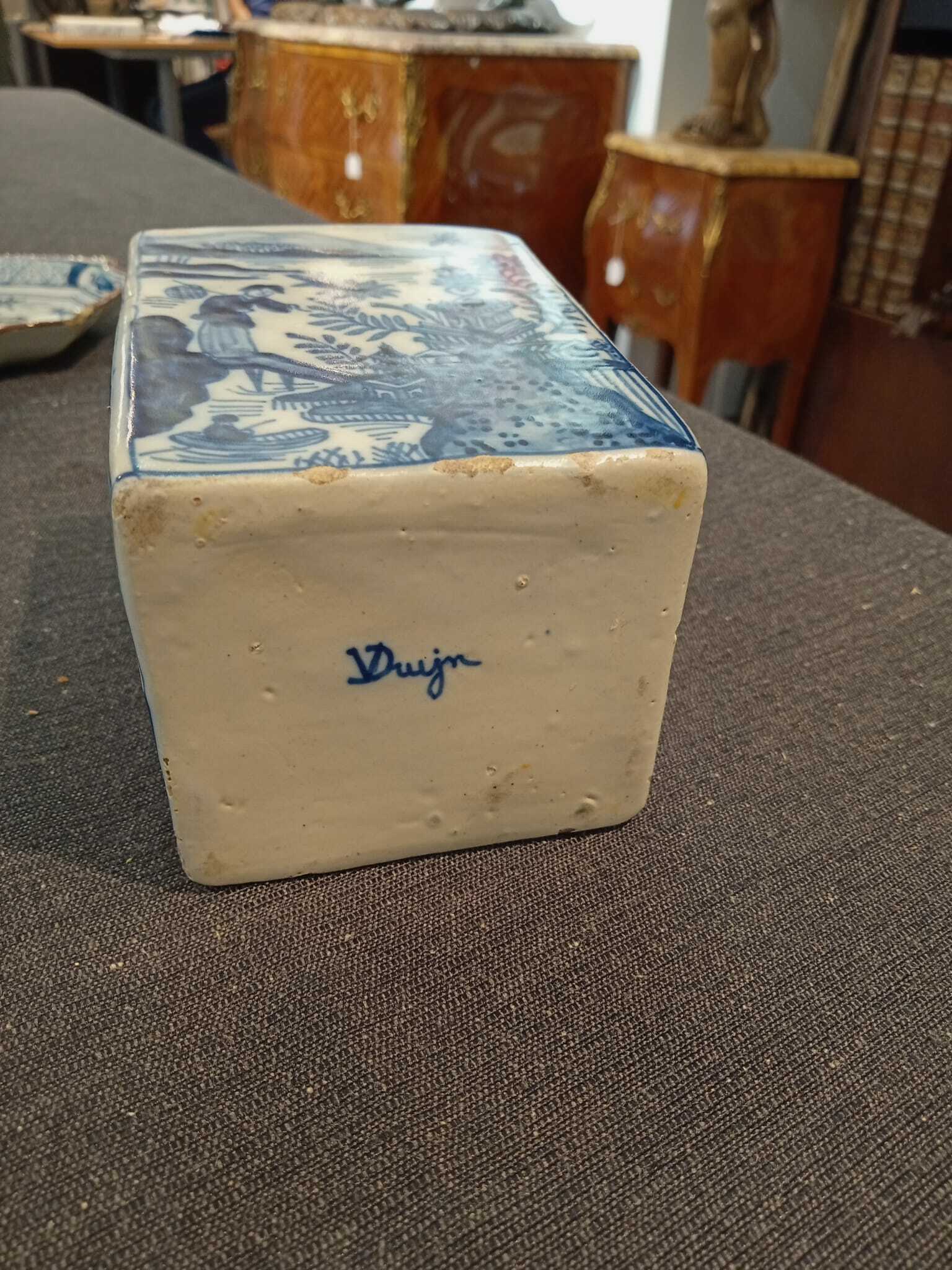 A varied collection of Dutch Delft blue and white items with figures in ...