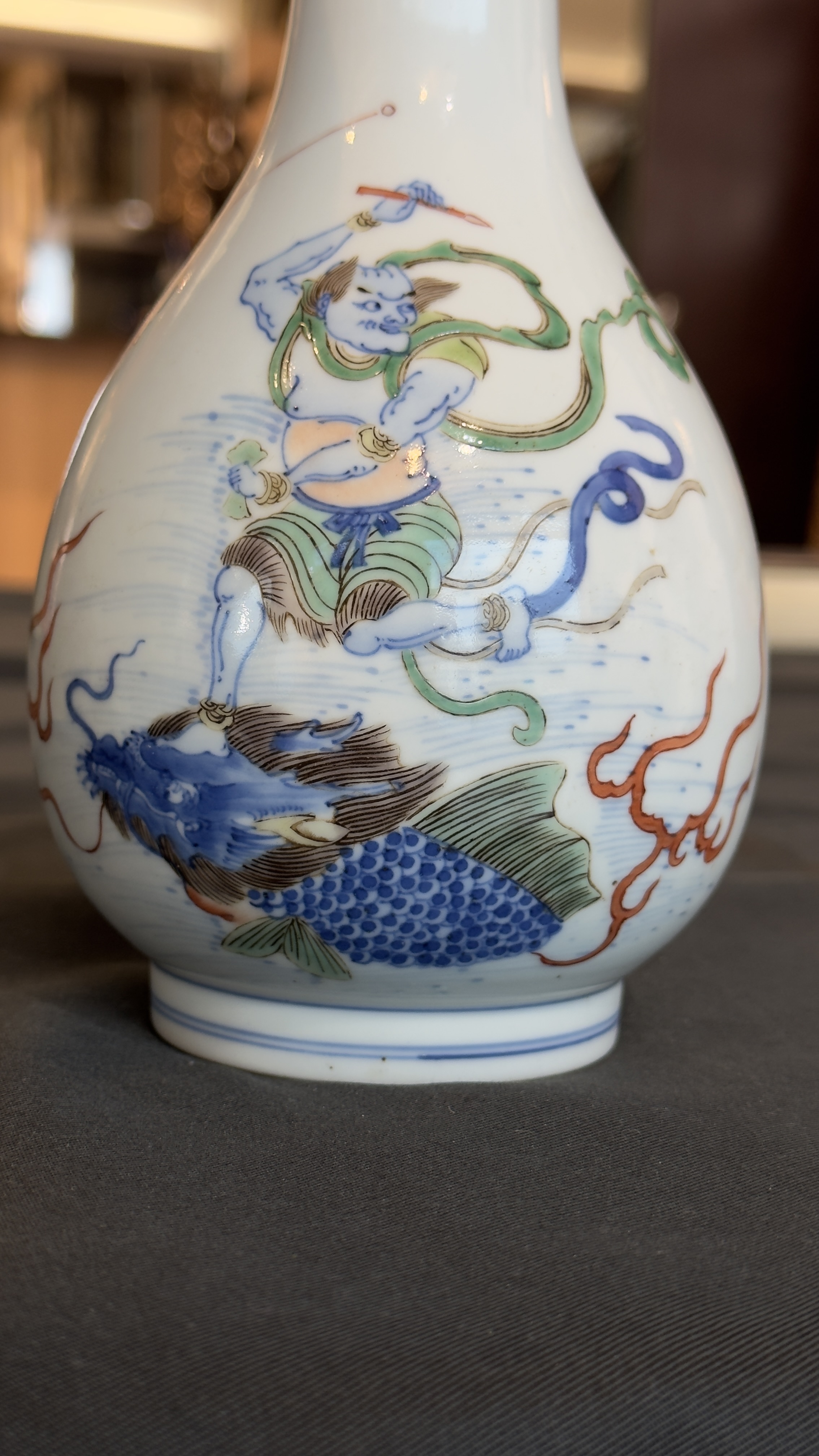 A Chinese doucai bottle-shaped and inscribed 'Kui Xing' vase on wooden ...