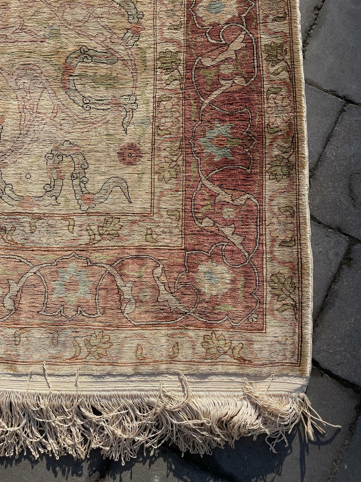 A fine Turkish silk and gold thread Hereke rug with floral design and ...