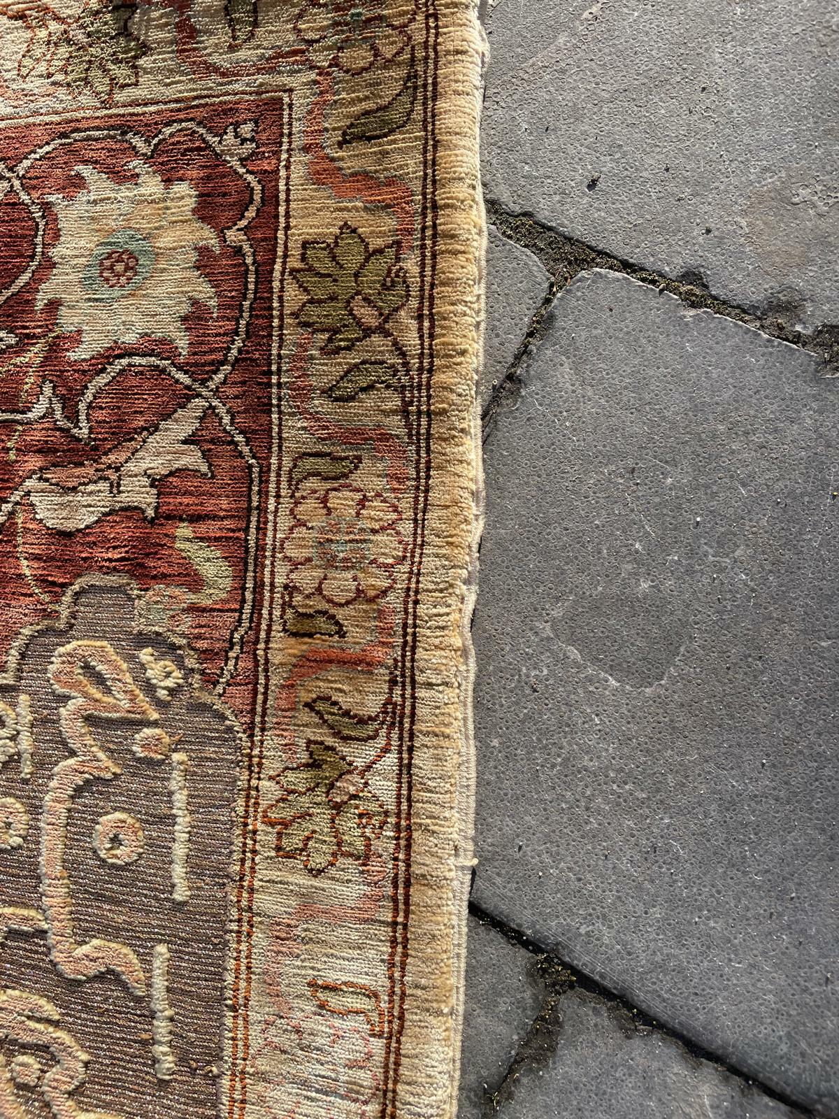 A fine Turkish silk and gold thread Hereke rug with floral design and ...